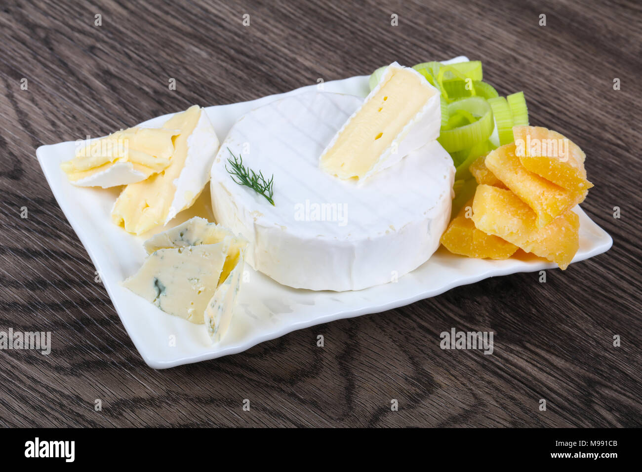 Cheese platter with brie, blue and parmesan Stock Photo - Alamy