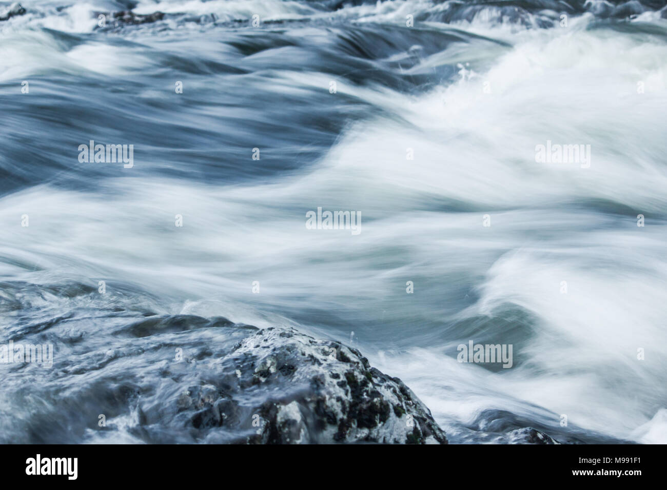 A powerful stream of mountain river. The fast current of water Stock ...