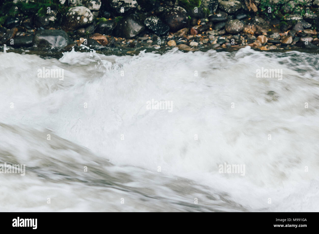 A powerful stream of mountain river. The fast current of water Stock ...