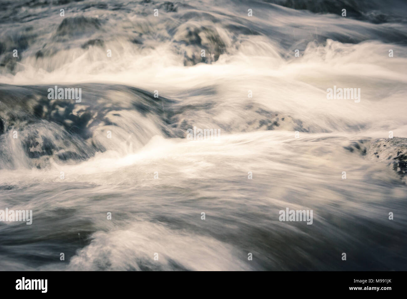 A powerful stream of mountain river. The fast current of water Stock ...