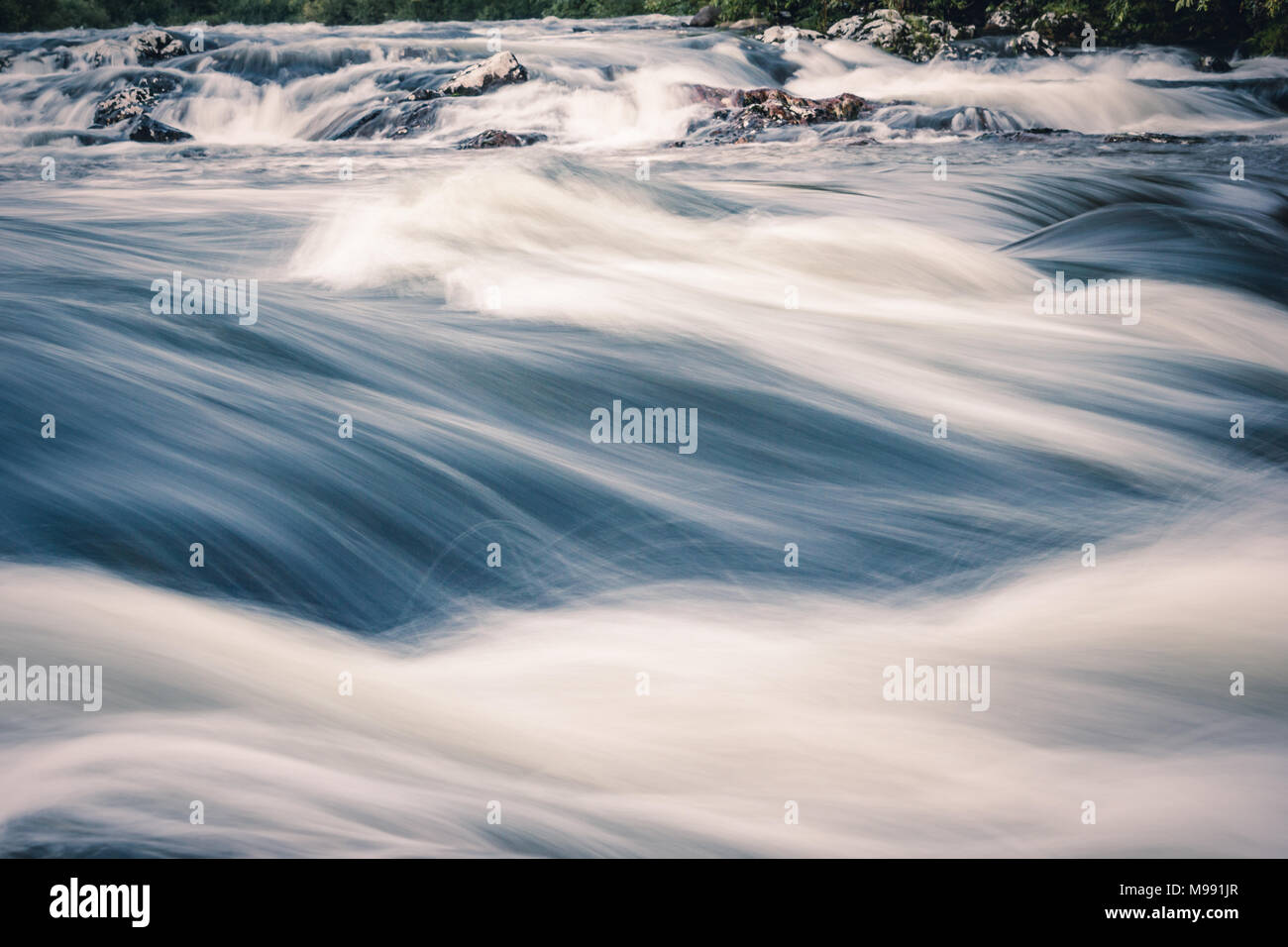 A powerful stream of mountain river. The fast current of water Stock ...