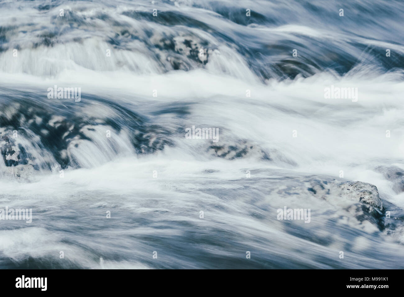 A powerful stream of mountain river. The fast current of water Stock ...