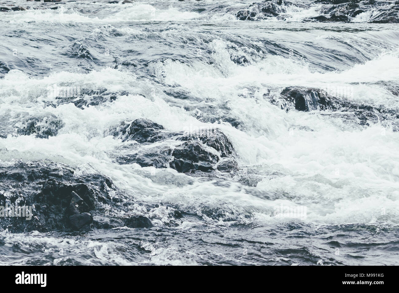 A powerful stream of mountain river. The fast current of water Stock ...