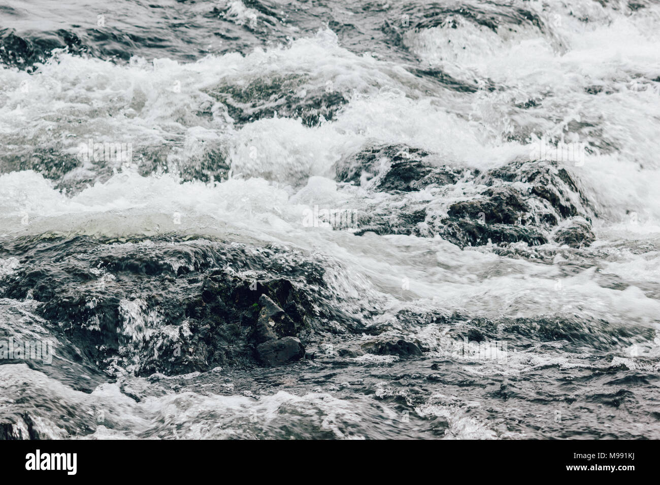 A powerful stream of mountain river. The fast current of water Stock ...