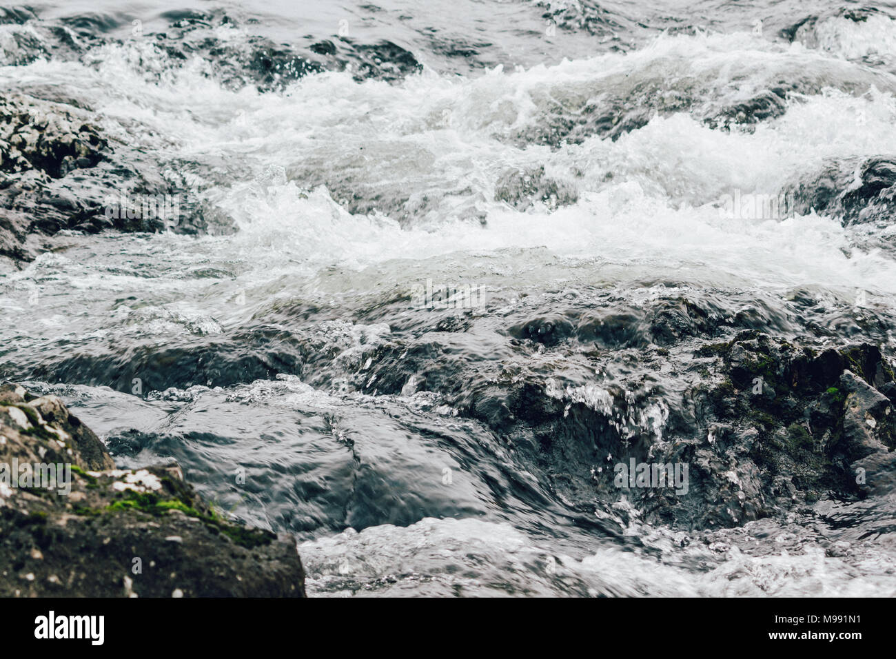 A powerful stream of mountain river. The fast current of water Stock ...