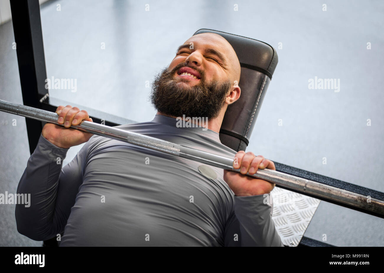 Strong man lifting weight in the gym, male athlete training at fitness ...