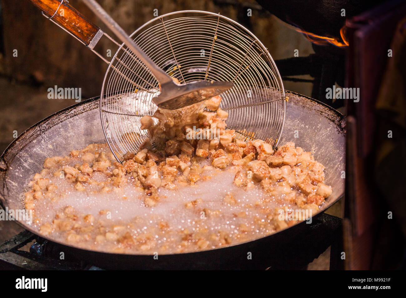 Fry the pork skin in a large frying pan on the stove.We will have a ...