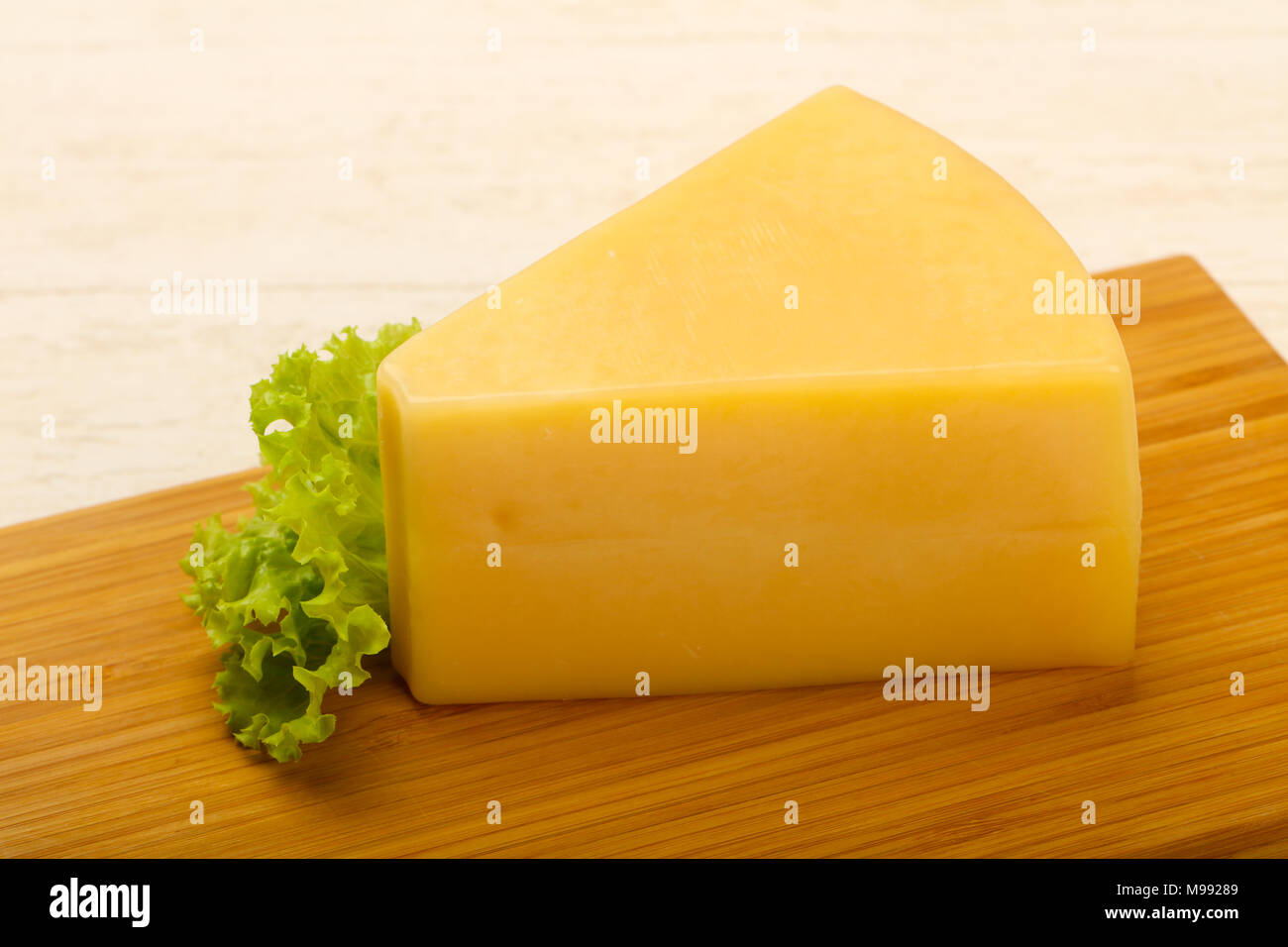 Parmesan cheese triangle Stock Photo - Alamy