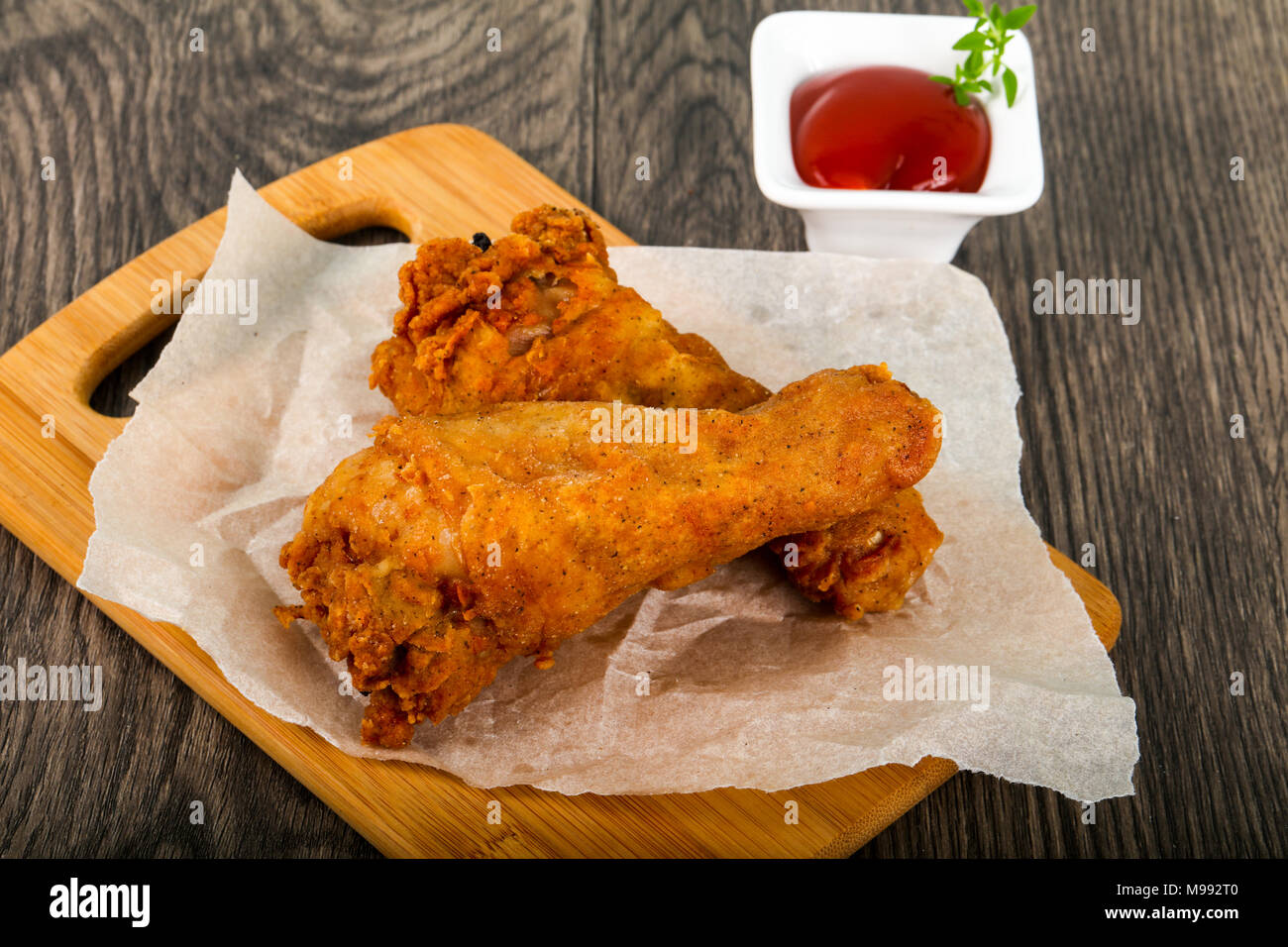 Crispy chicken legs with ketchup Stock Photo - Alamy