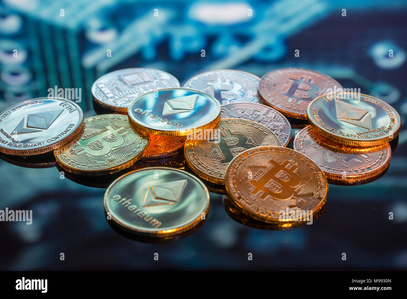 Bitcoin gold, silver and copper coins and defocused printed circuit ...
