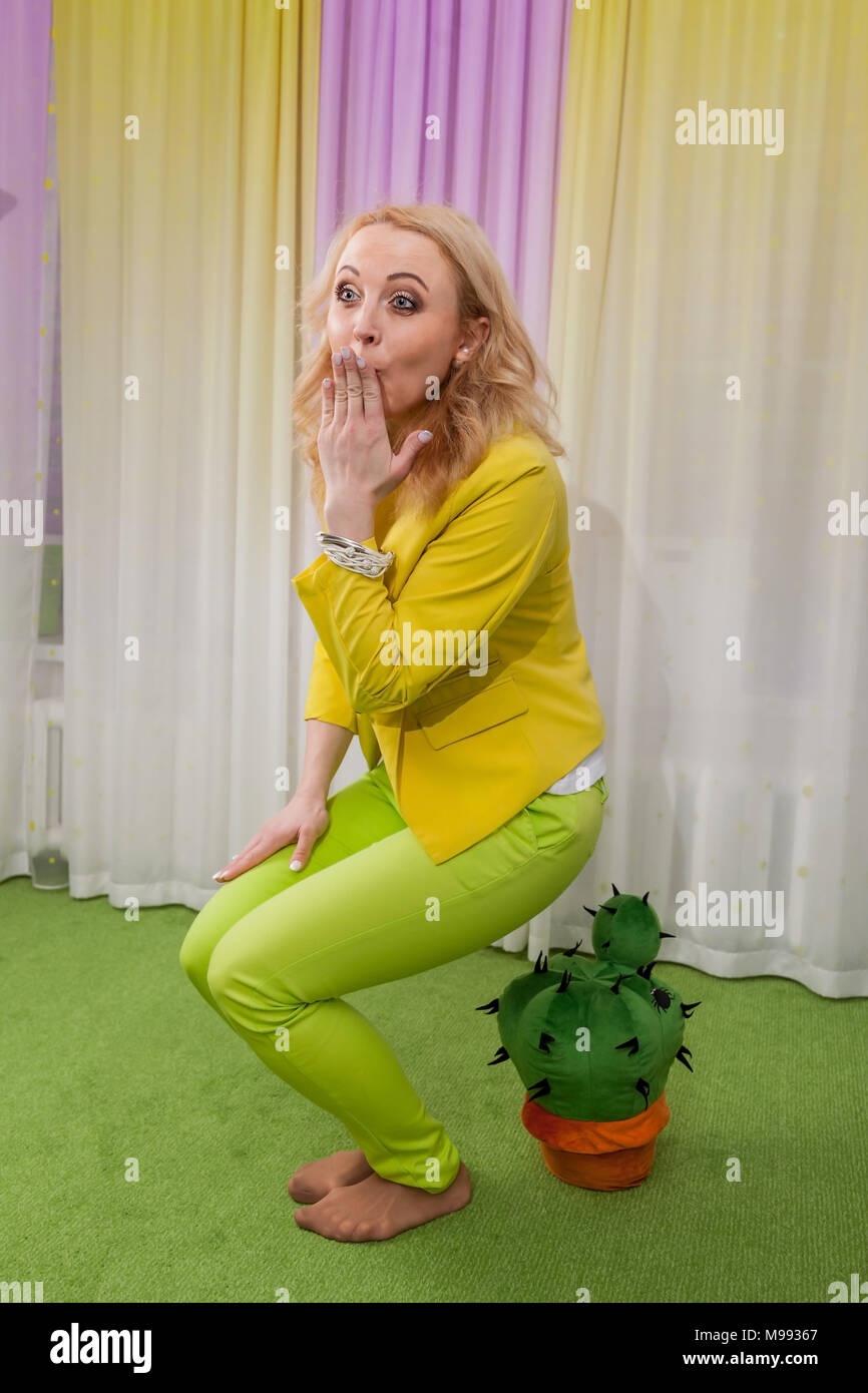 A woman sits on a cactus Stock Photo - Alamy