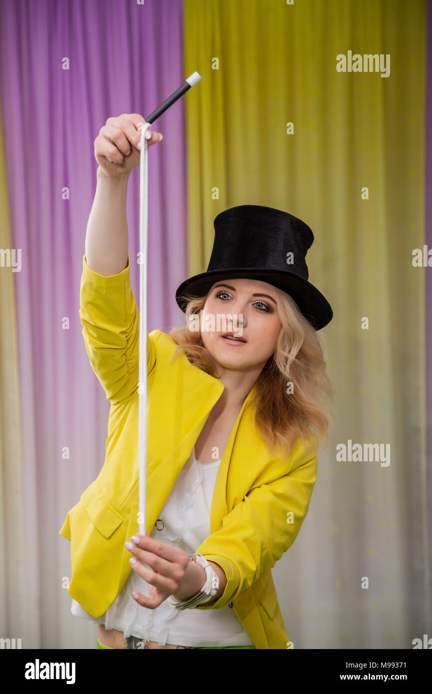 Woman magician shows tricks Stock Photo - Alamy