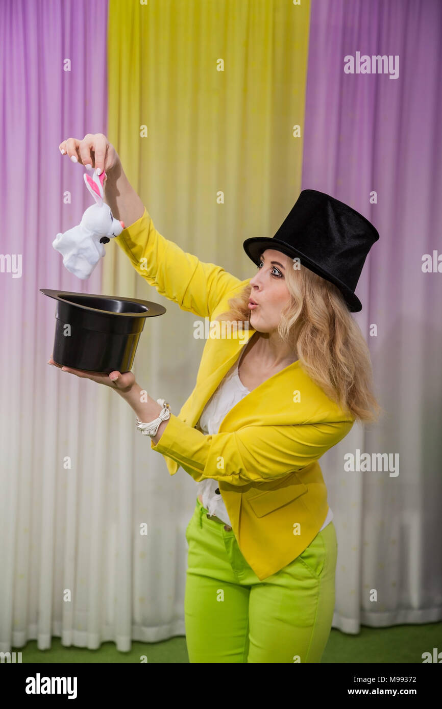 Woman magician shows tricks Stock Photo - Alamy