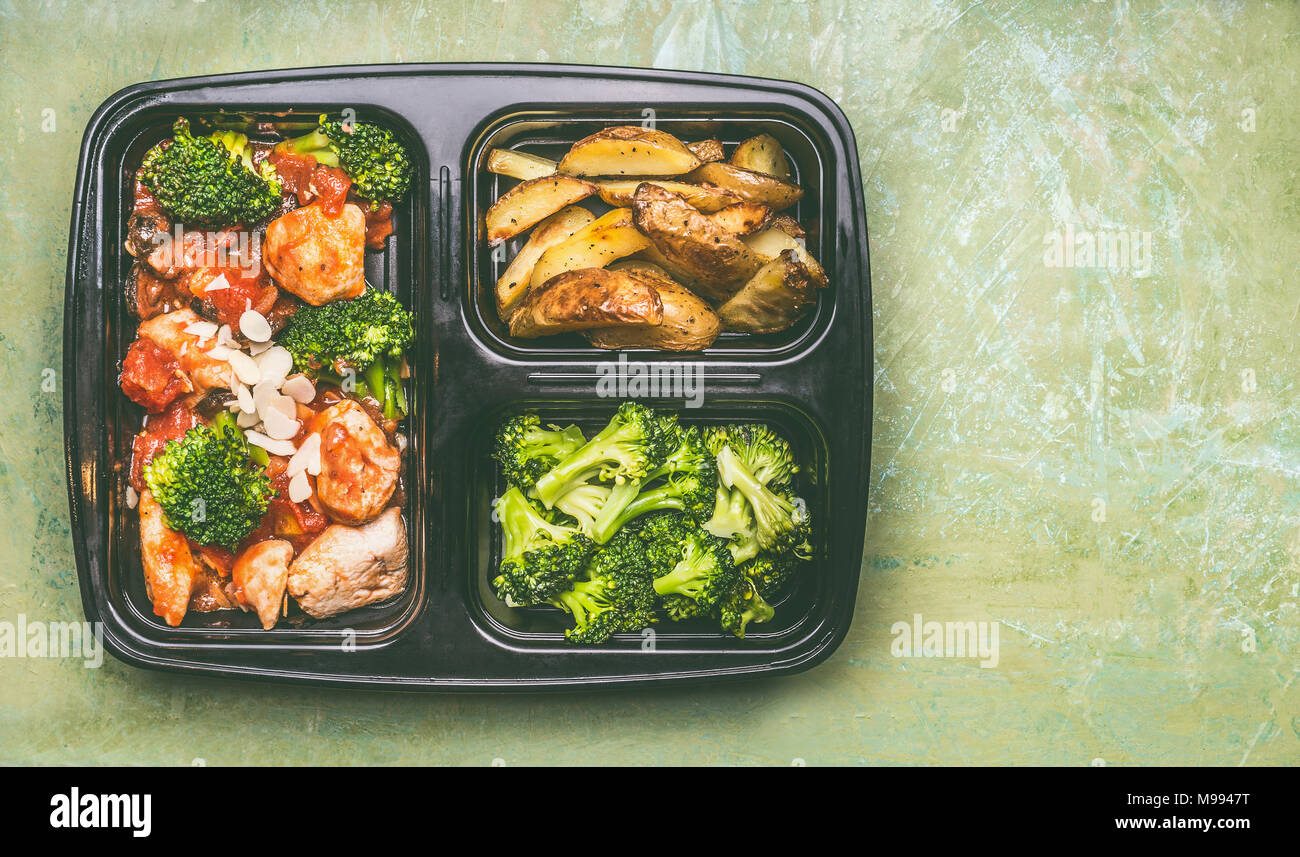 Healthy balanced lunch box with chicken pieces in tomatoes sauce with ...