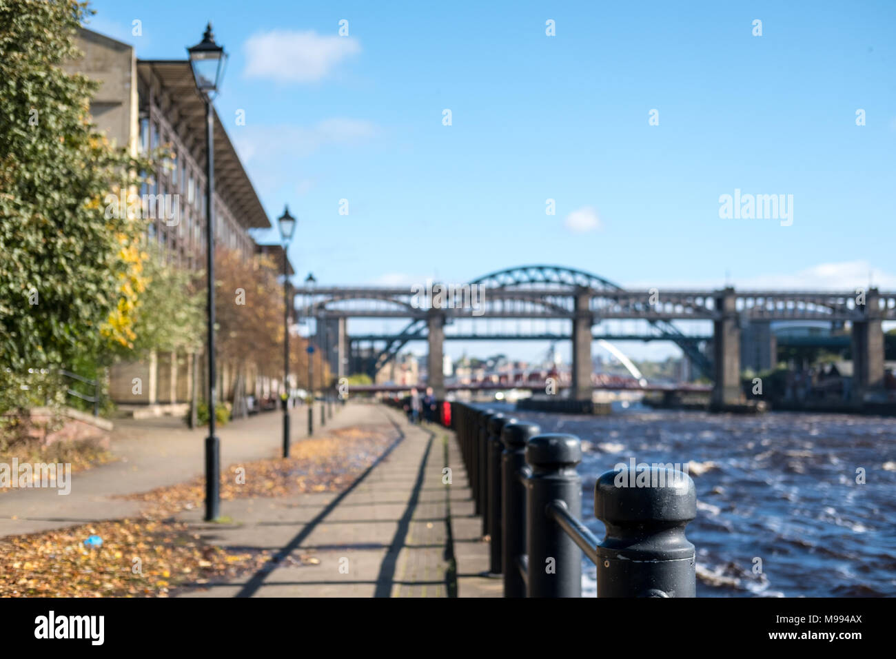 Quayside along Tyne River, in Newcastle, England. With blurred image of ...