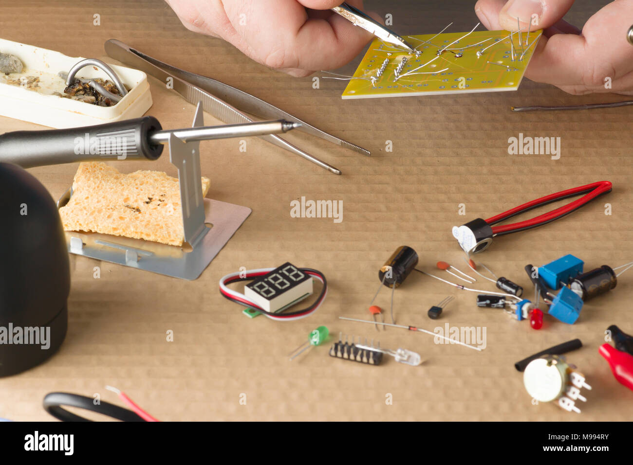 master repairs electronic equipment at his workplace Stock Photo - Alamy