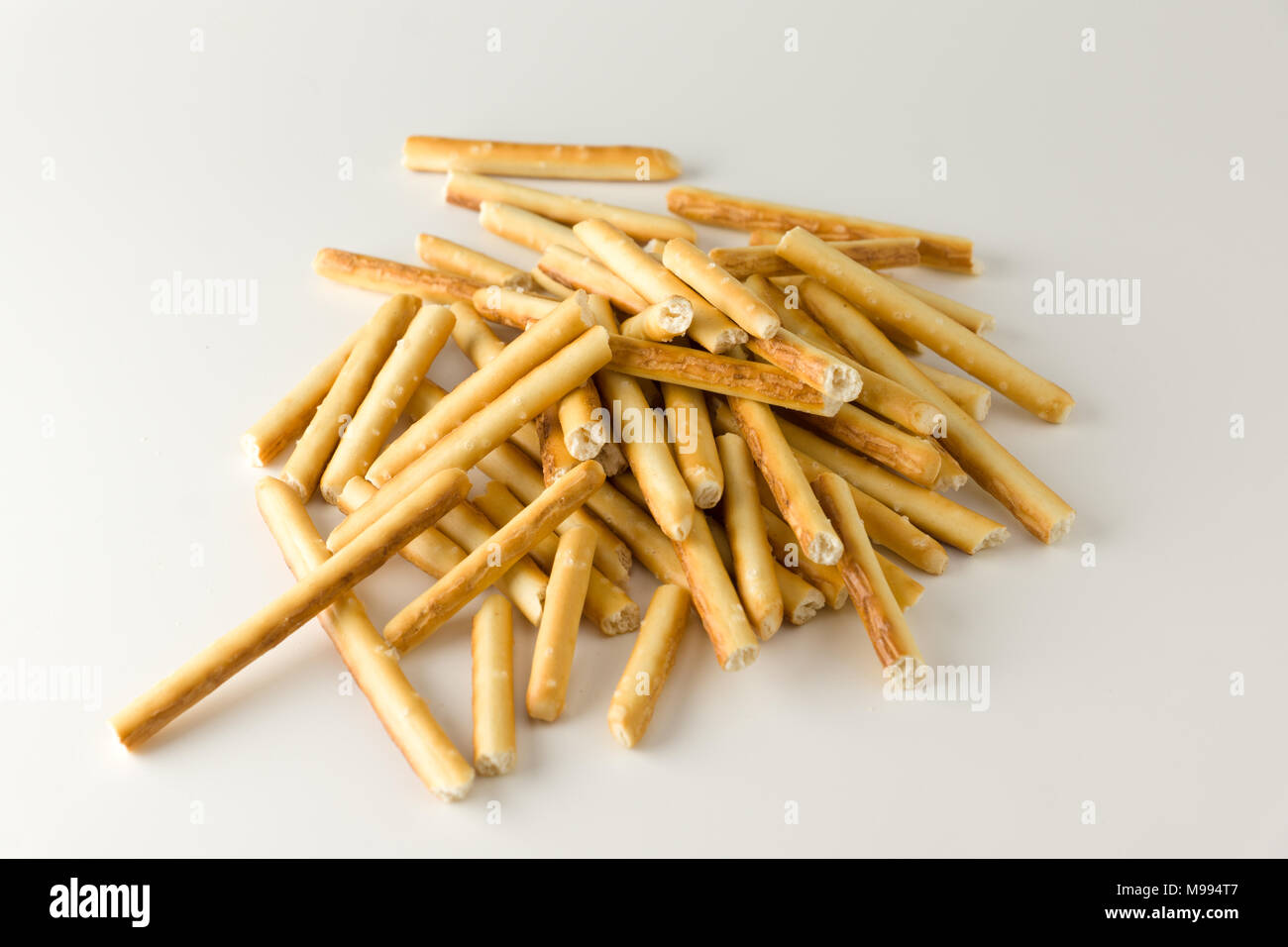 Crispy flour sticks lined on a white background Stock Photo - Alamy