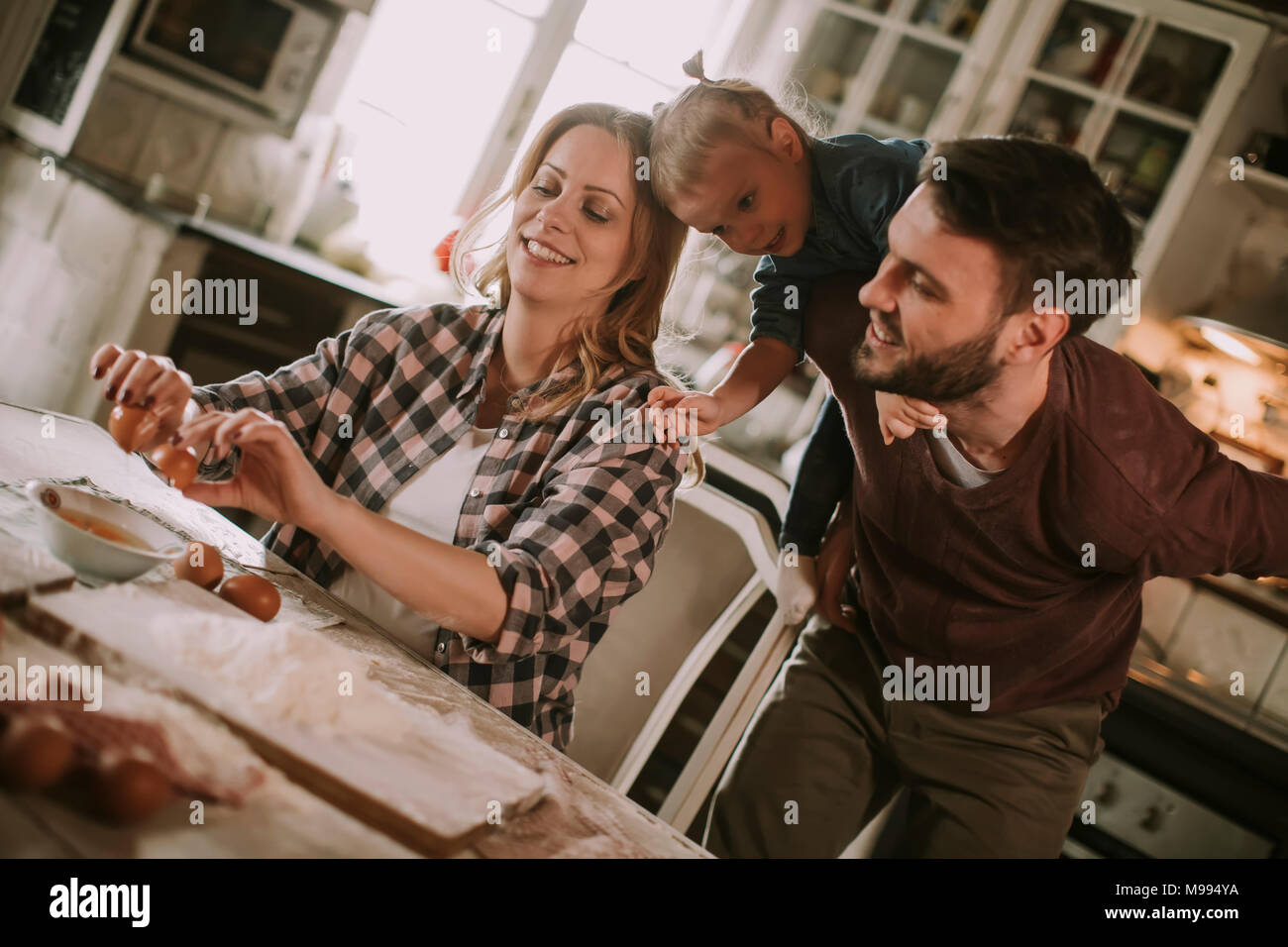 Happy family making pasta in the kitchen at home Stock Photo - Alamy