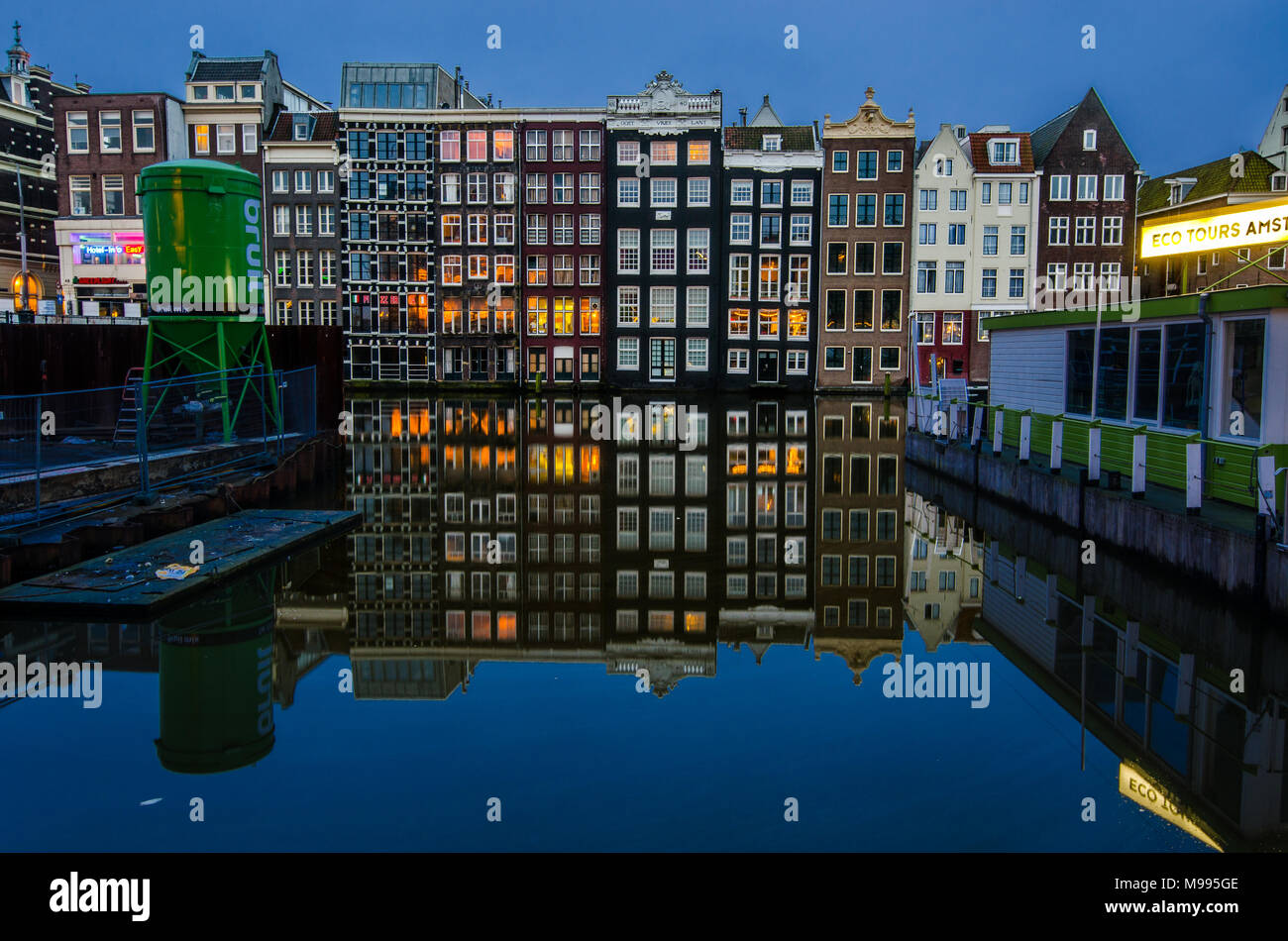 Houses, reflection in water during blue hour Stock Photo - Alamy