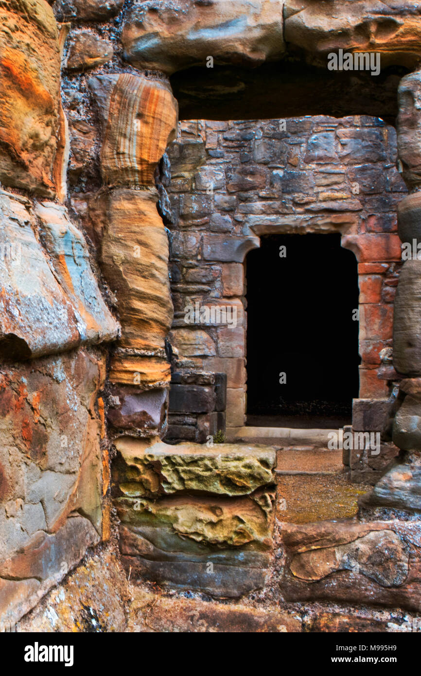 Dark rectangular doorway and window with buttress detail showing ...