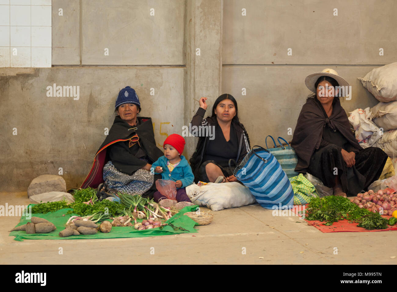 Unidentified indigenous native Quechua market traders selling fruit and ...