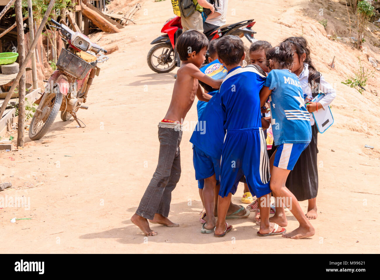 Children fight over gifts brought by toursts to a poor, rural village ...