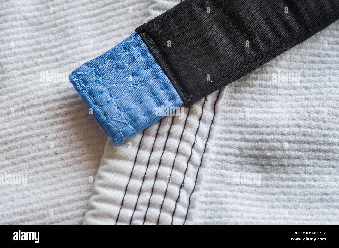 Blue belt of Brazilian Jiu-Jitsu with four degrees, on top of the ...