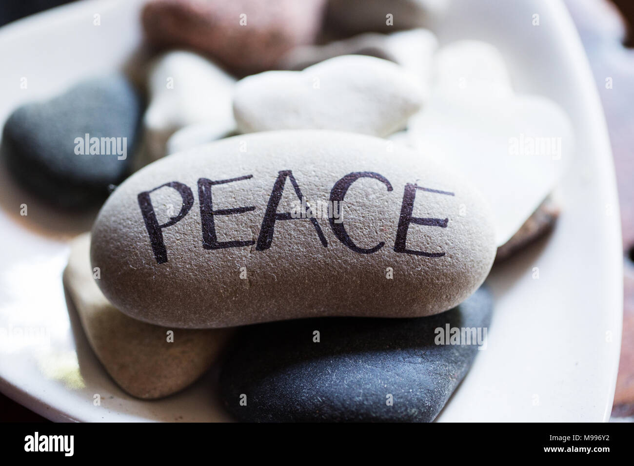 A smooth rock with handwritten PEACE message Stock Photo - Alamy