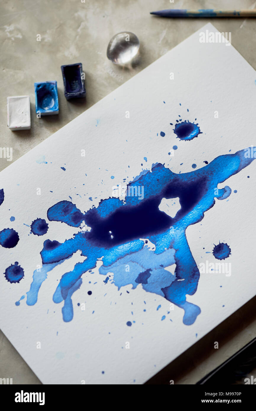 Blue ink blot art,the attributes for the artist Stock Photo - Alamy
