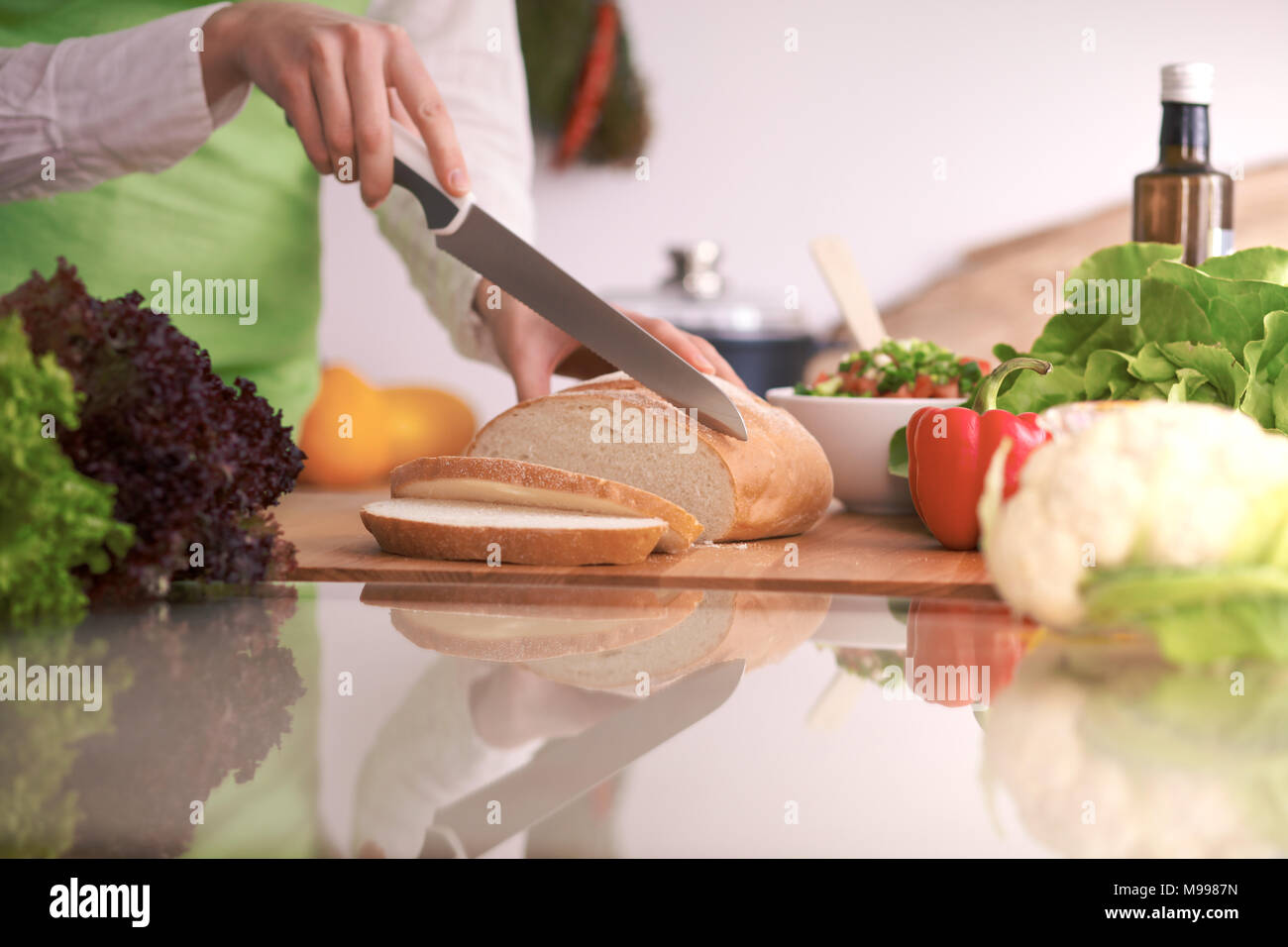 Closeup of human hands cooking in kitchen on the glass table with ...