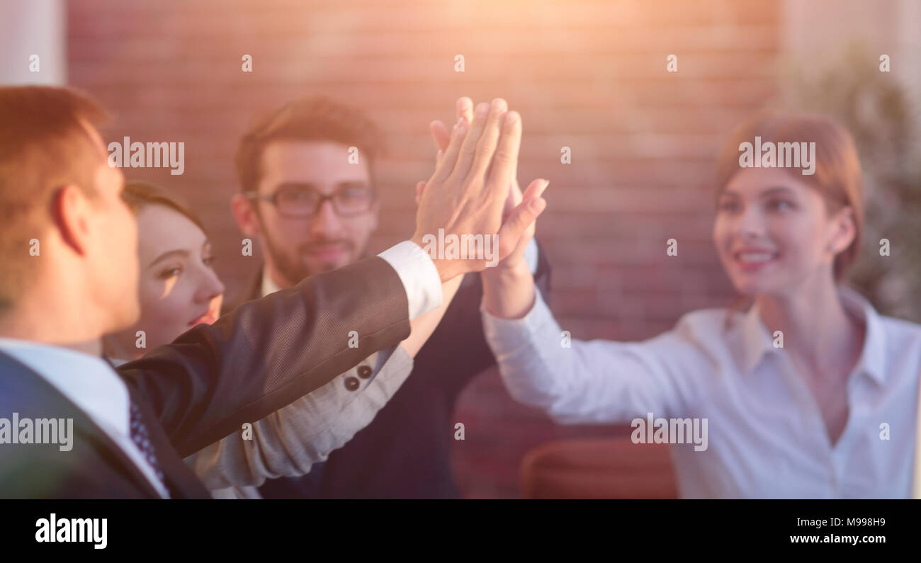 successful business team giving each other a high five Stock Photo - Alamy