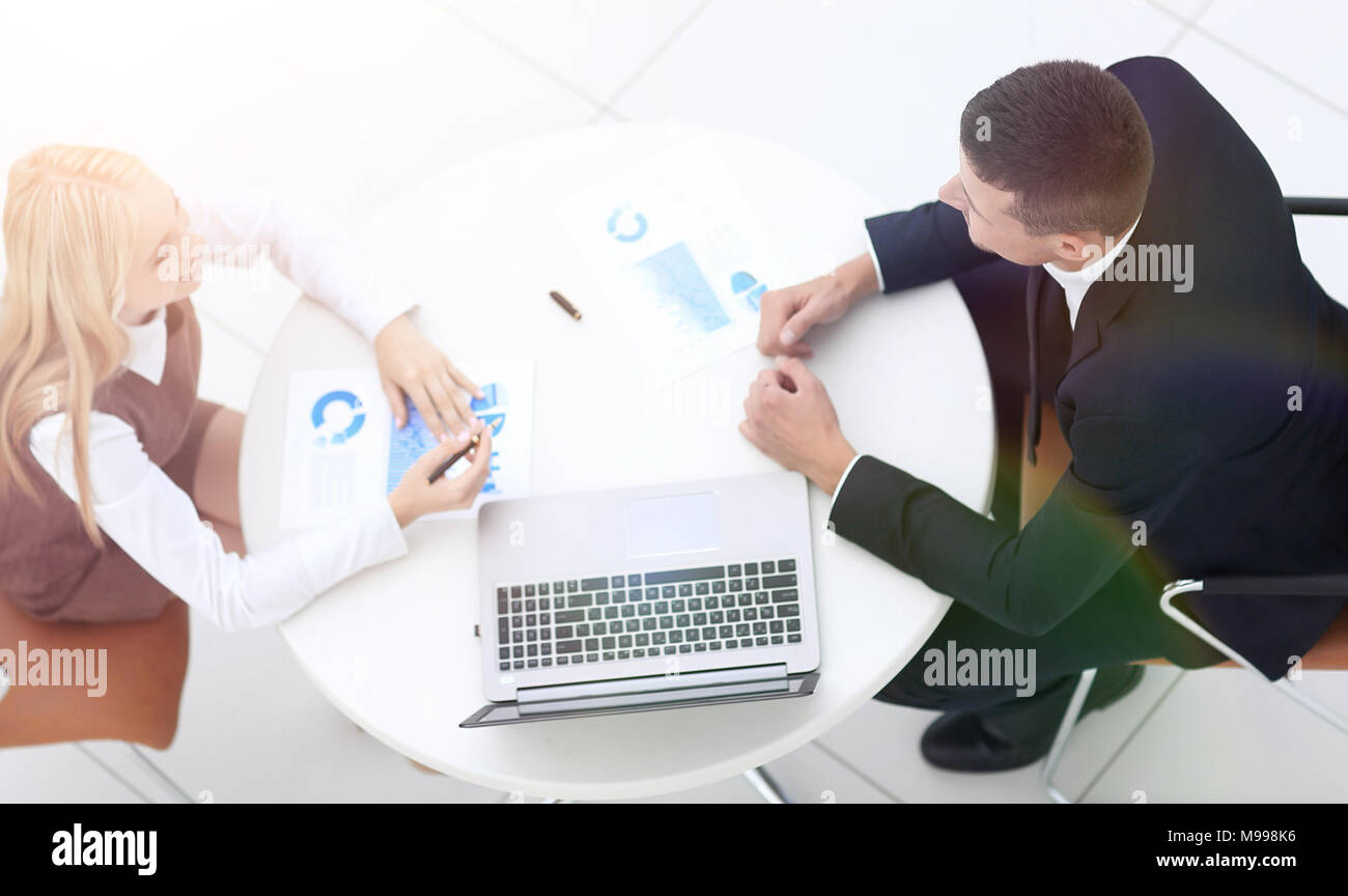 two employees discussing financial charts Stock Photo - Alamy