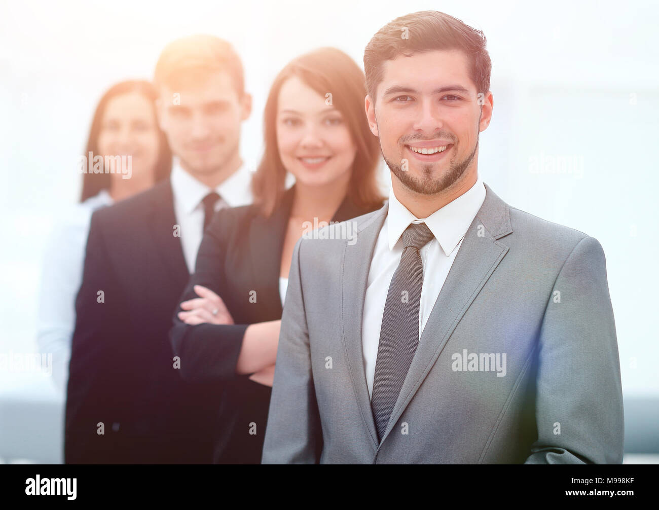leader and the business team standing one behind the other Stock Photo ...