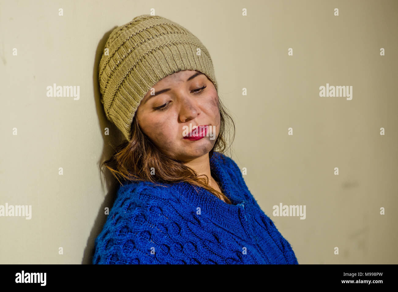 Portrait of homeless woman on the street in cold autumn weather wearing ...