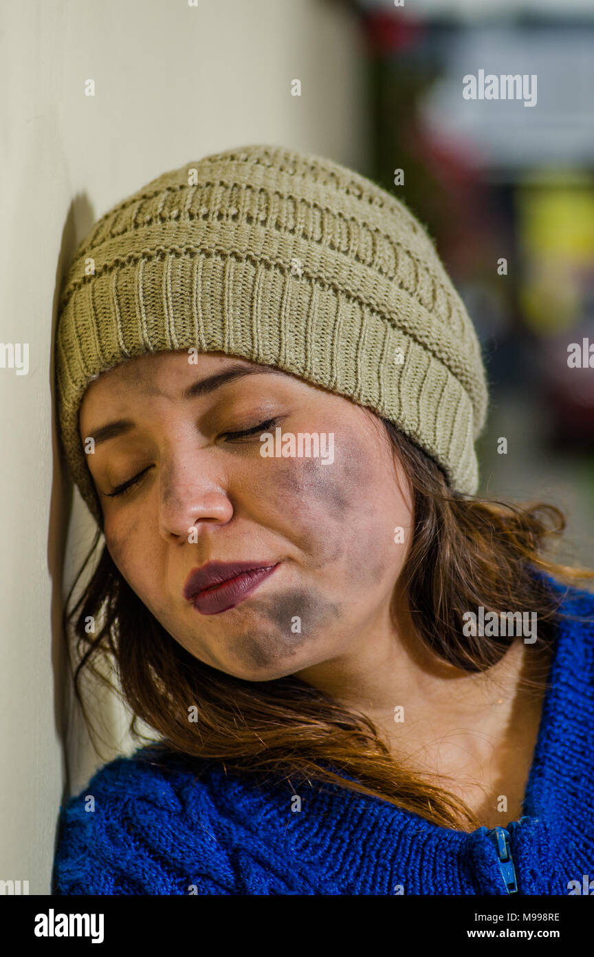 Portrait of homeless woman on the street in cold autumn weather wearing ...