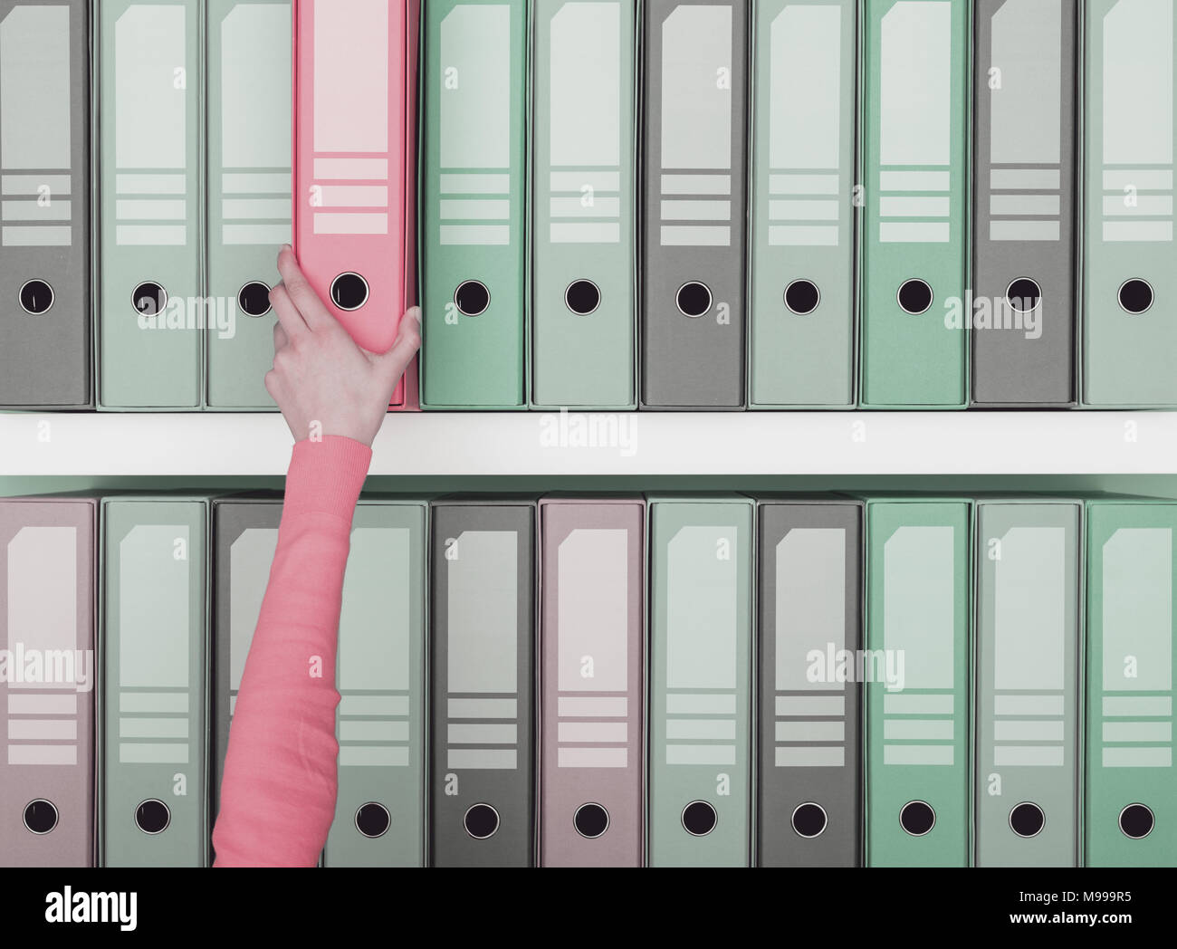 Office worker finding a folder in the archive: database, administration ...