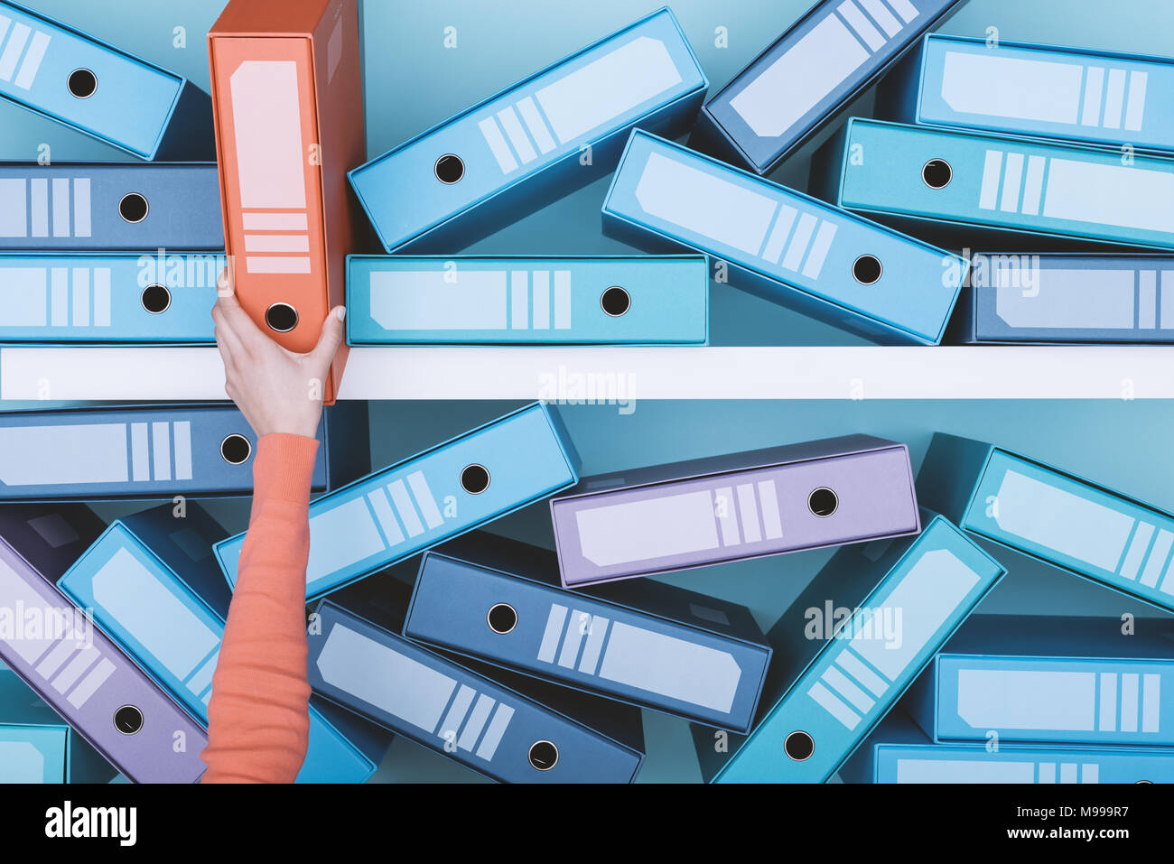 Office worker finding a folder in the messy archive, management and administration concept Stock ...