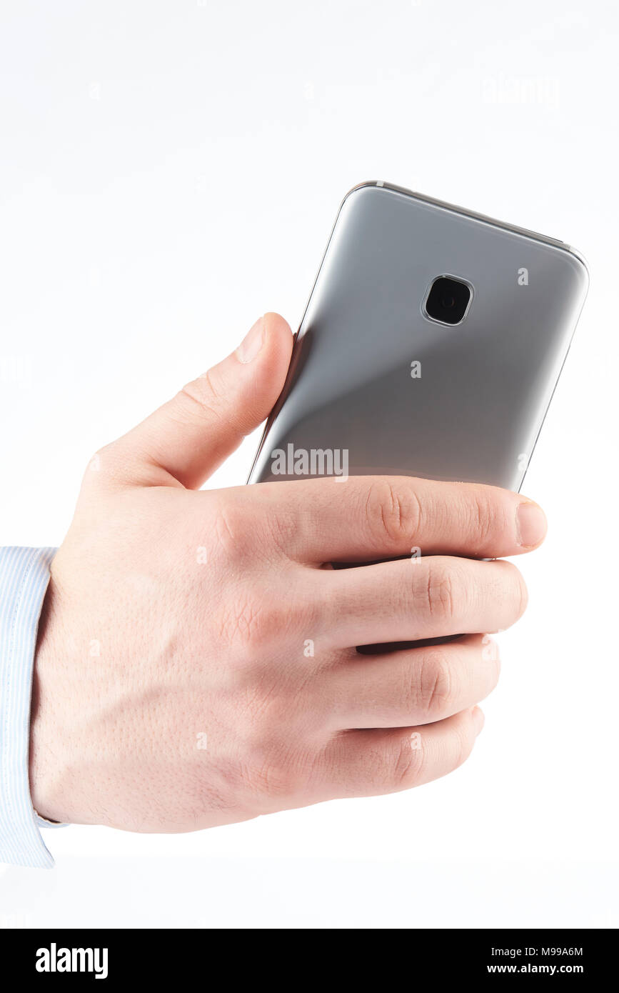 Back view of smartphone in hand with camera isolated on white ...