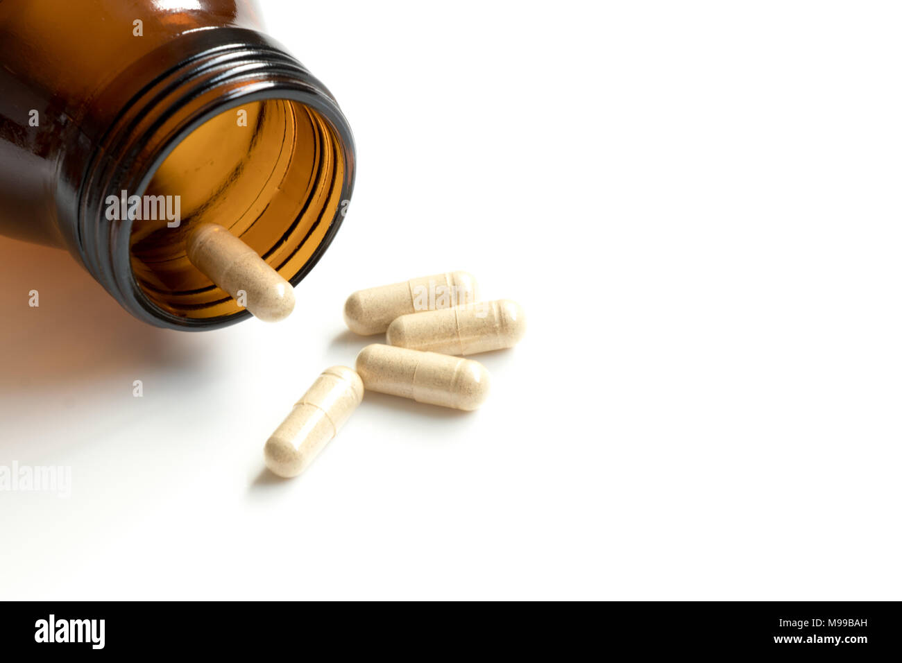 Capsule with amber bottle on white background and have the copy space ...