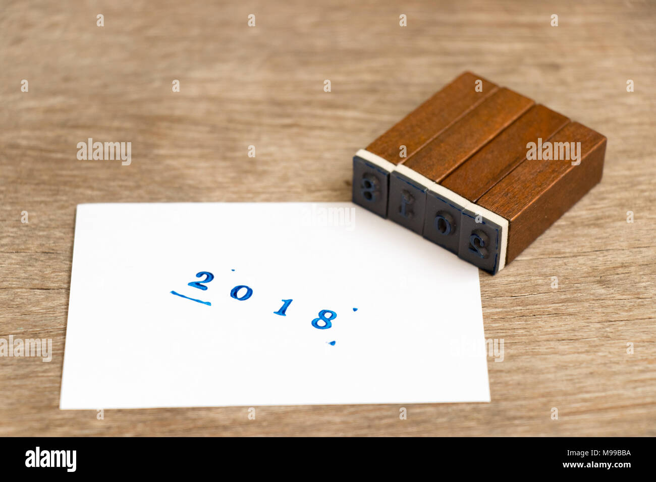 Blue wording 2018 on white paper with wood block stamp on wood ...