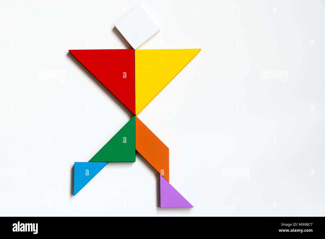 Colorwood tangram puzzle on human walking shape on white background ...