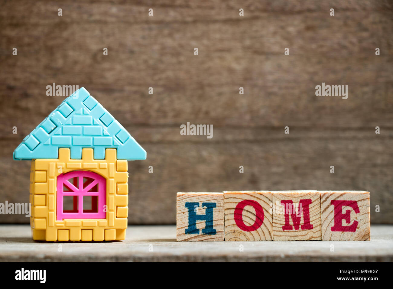 Puzzle model in home shape with block in home wording on wood ...