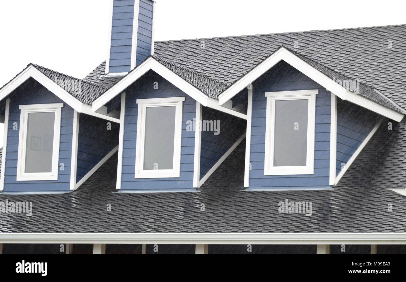 Blue house with three dormers in a rainy day Stock Photo - Alamy
