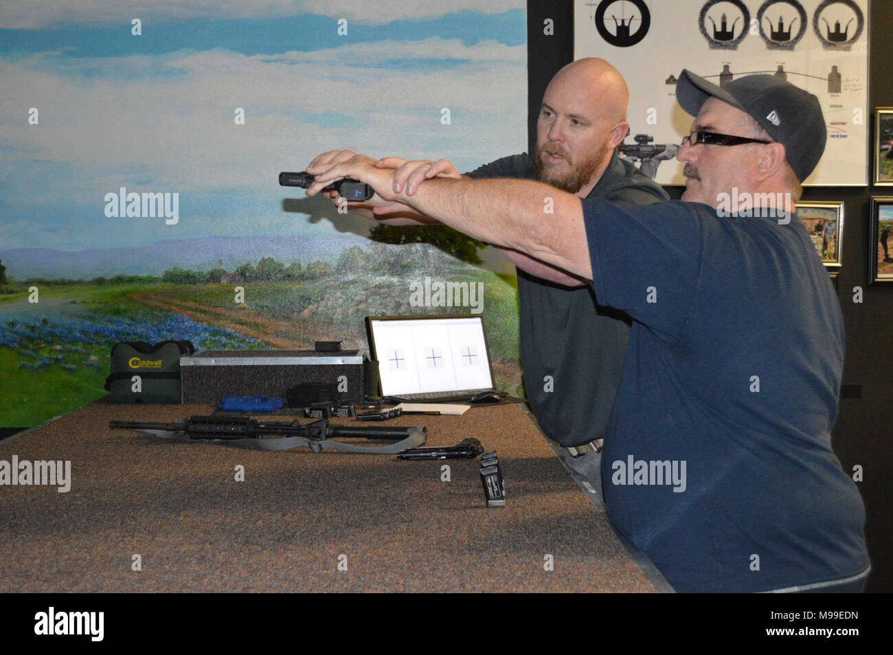 Scott Fitzgerald (far), Firearms Training Simulator instructor, works ...