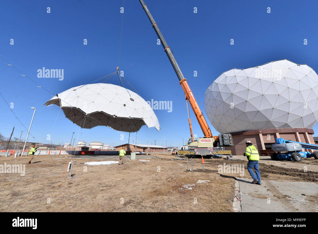 Employees from SAS construction disassemble the protective enclosure ...
