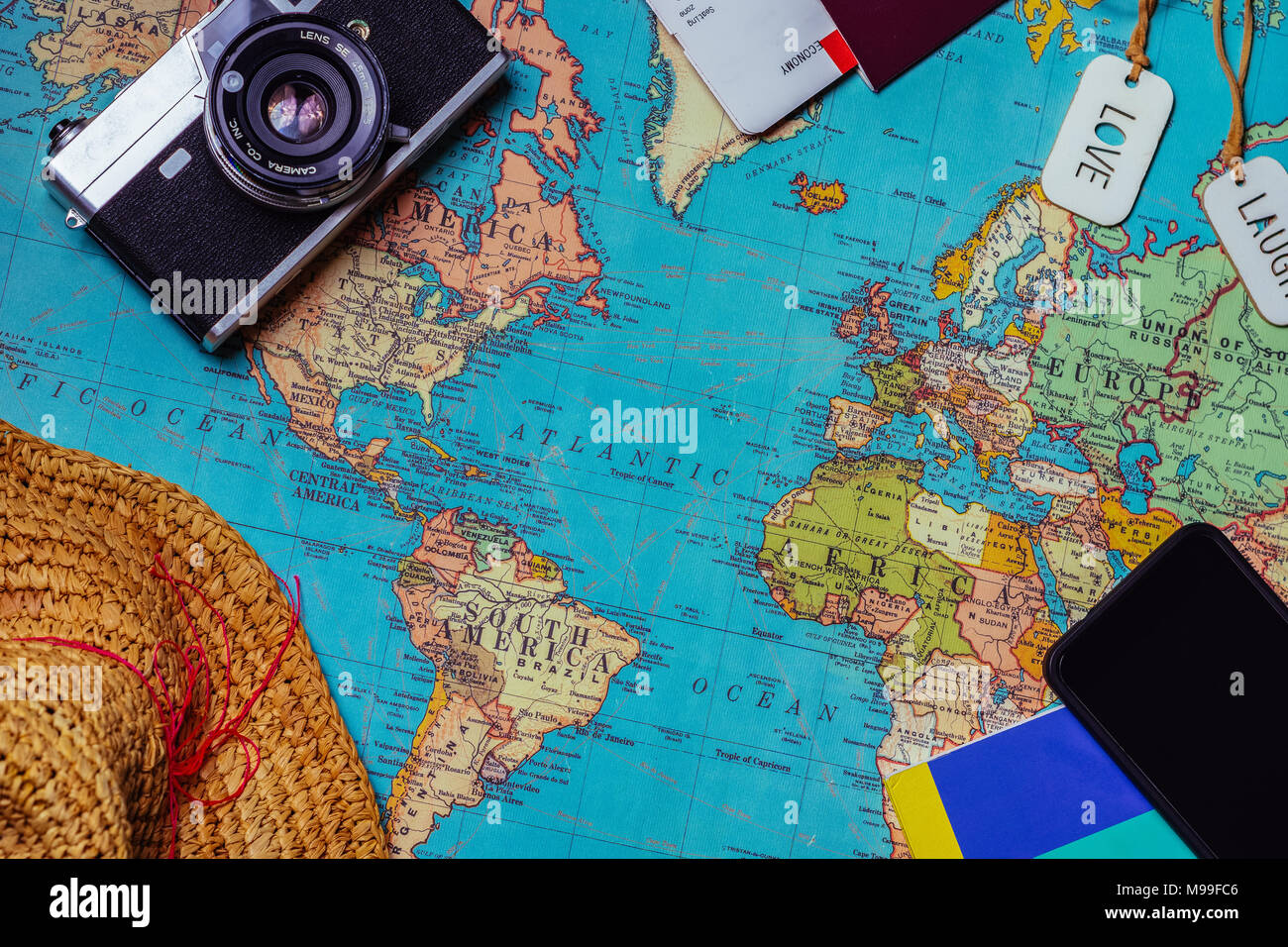 Travel concept background with a retro camera, a hat, a note book, a ...
