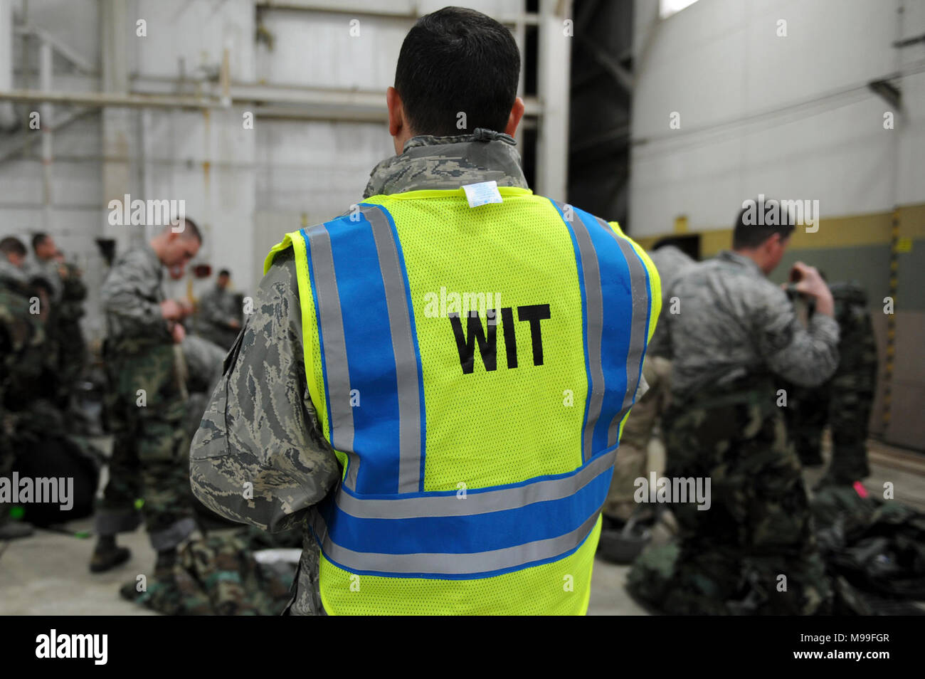 A wing inspection team member evaluate Airmen donning mission ...