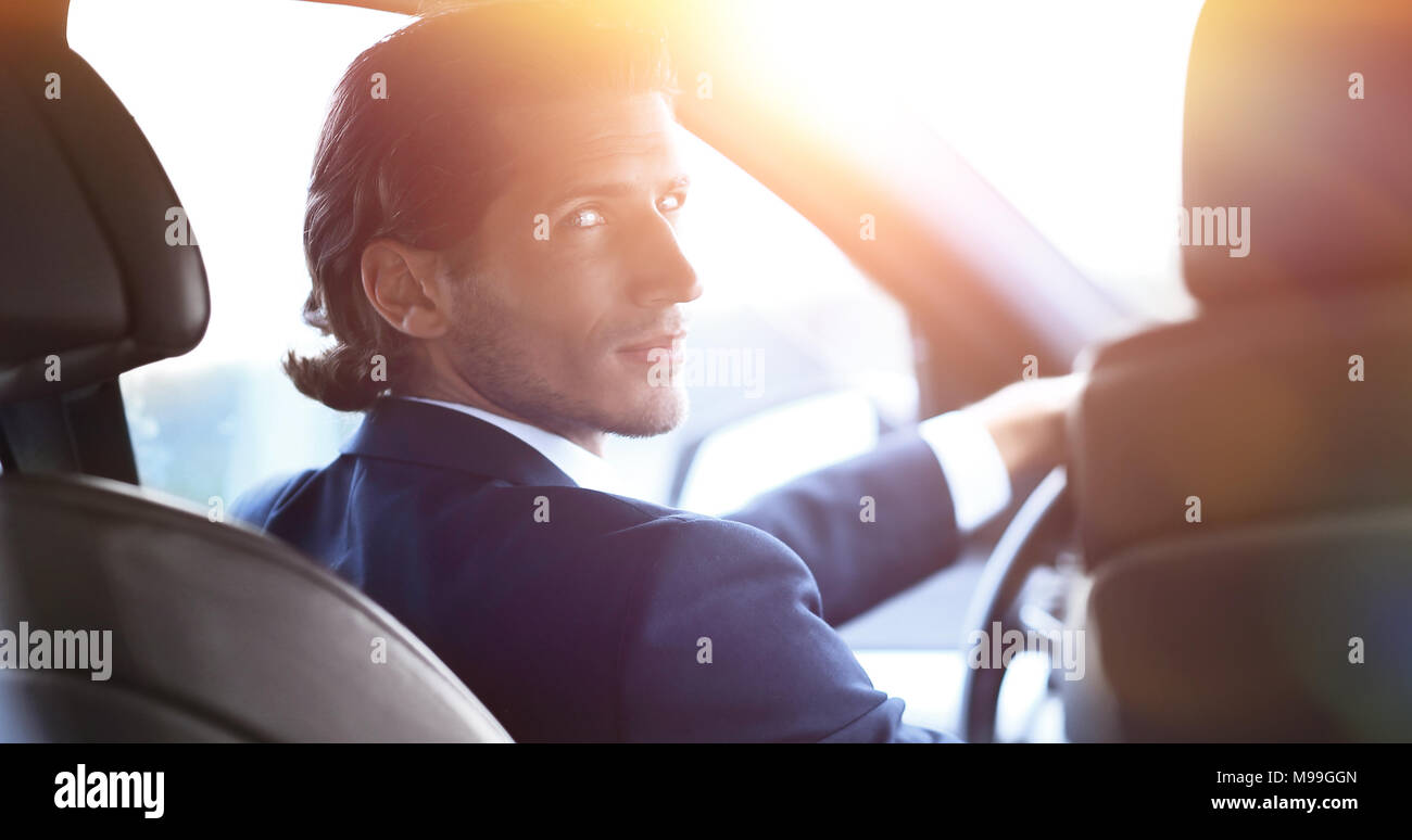 man sitting behind the wheel of a car Stock Photo - Alamy