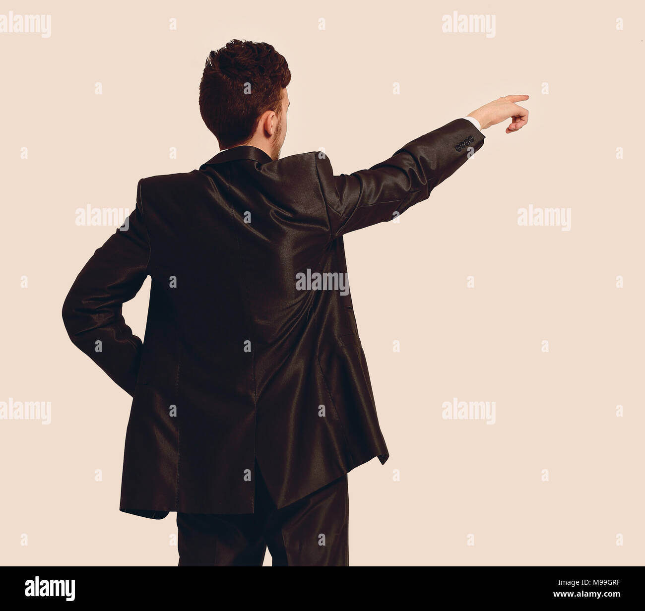 Full length of business man pointing at copyspace Stock Photo - Alamy