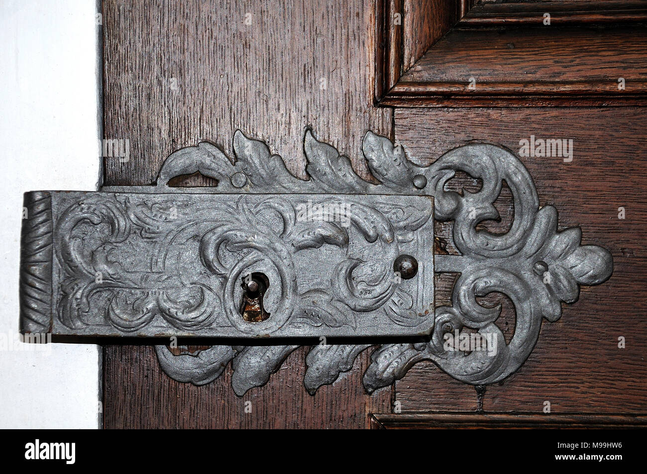 wrought iron baroque lock at oak wooden door Stock Photo - Alamy
